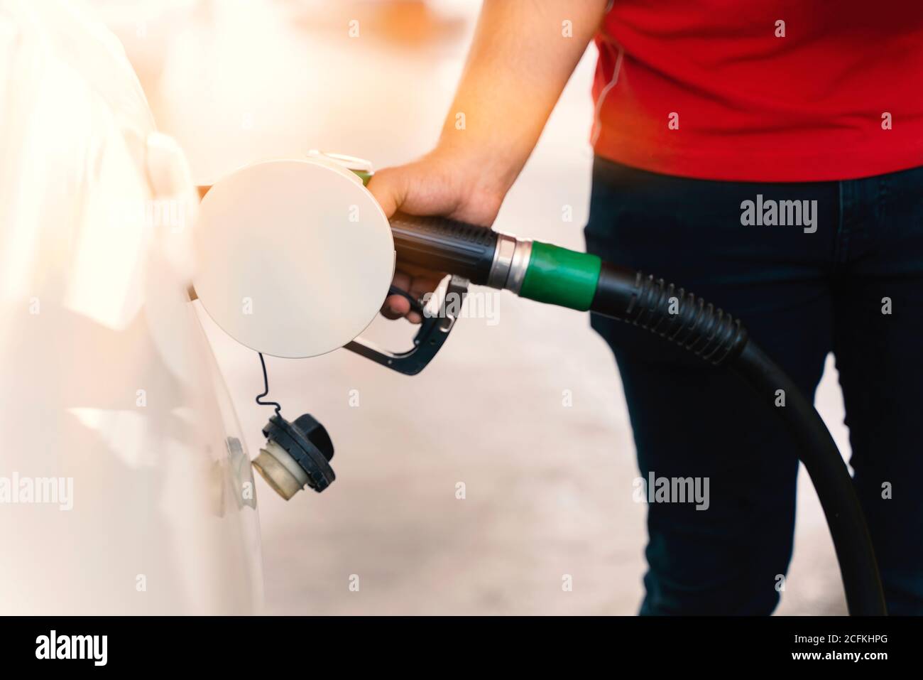 Hand holding a green pistol for automatic petrol pump Stock Photo - Alamy