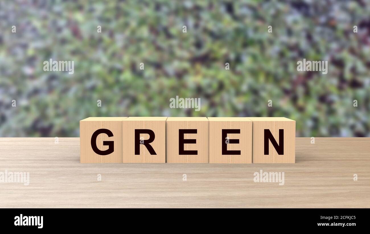 Green word wooden cubes on table vertical over blur background with ...