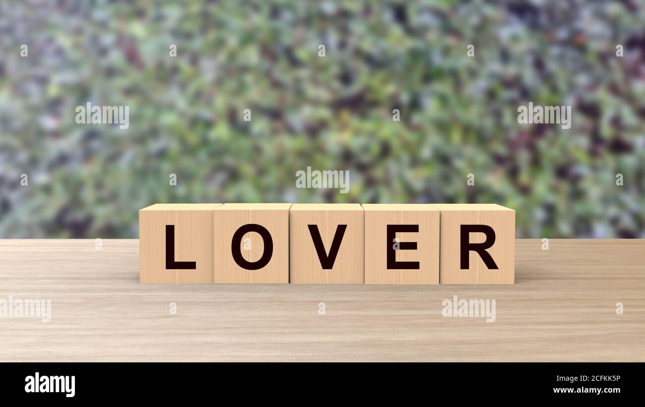 Lover word Wooden cubes on table over background leaves green HD, mock ...