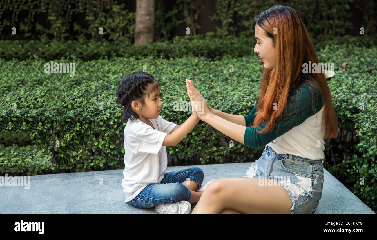 girls playing push hand with music outdoor exercise with sister Stock ...