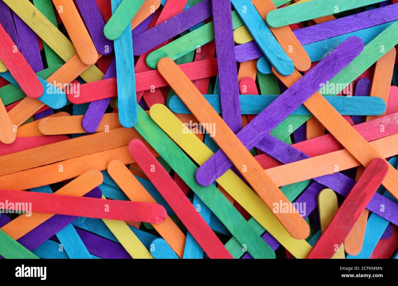 Multicolored popsicle sticks in bulk in shades of purple red light blue ...