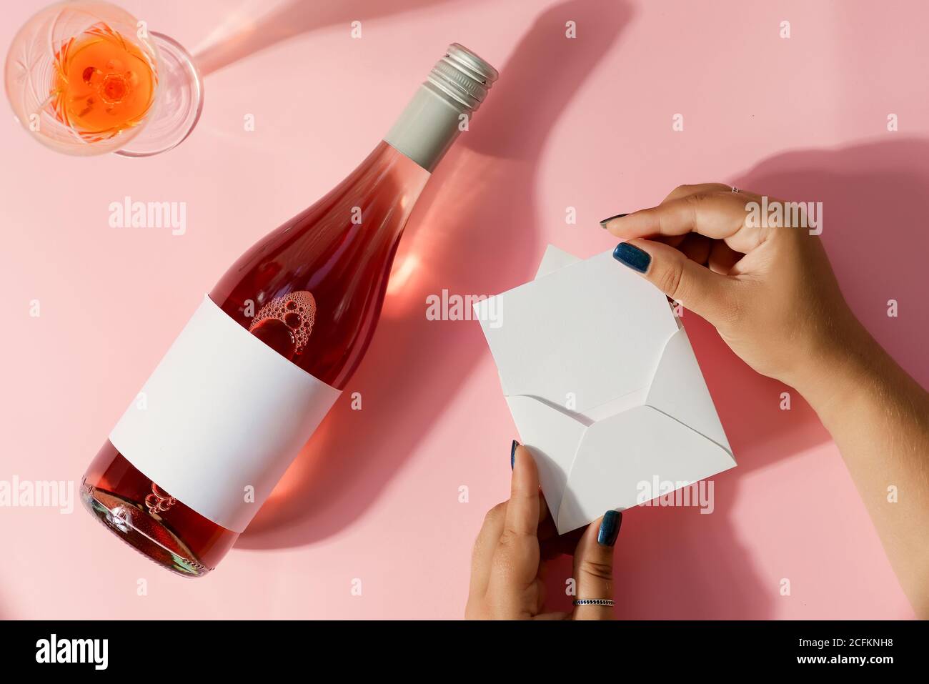 Greeting postcard with bottle of rose wine and envelope letter card in ...