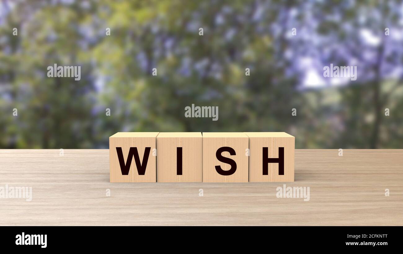 Wish word wooden cubes on table vertical over blur background with ...