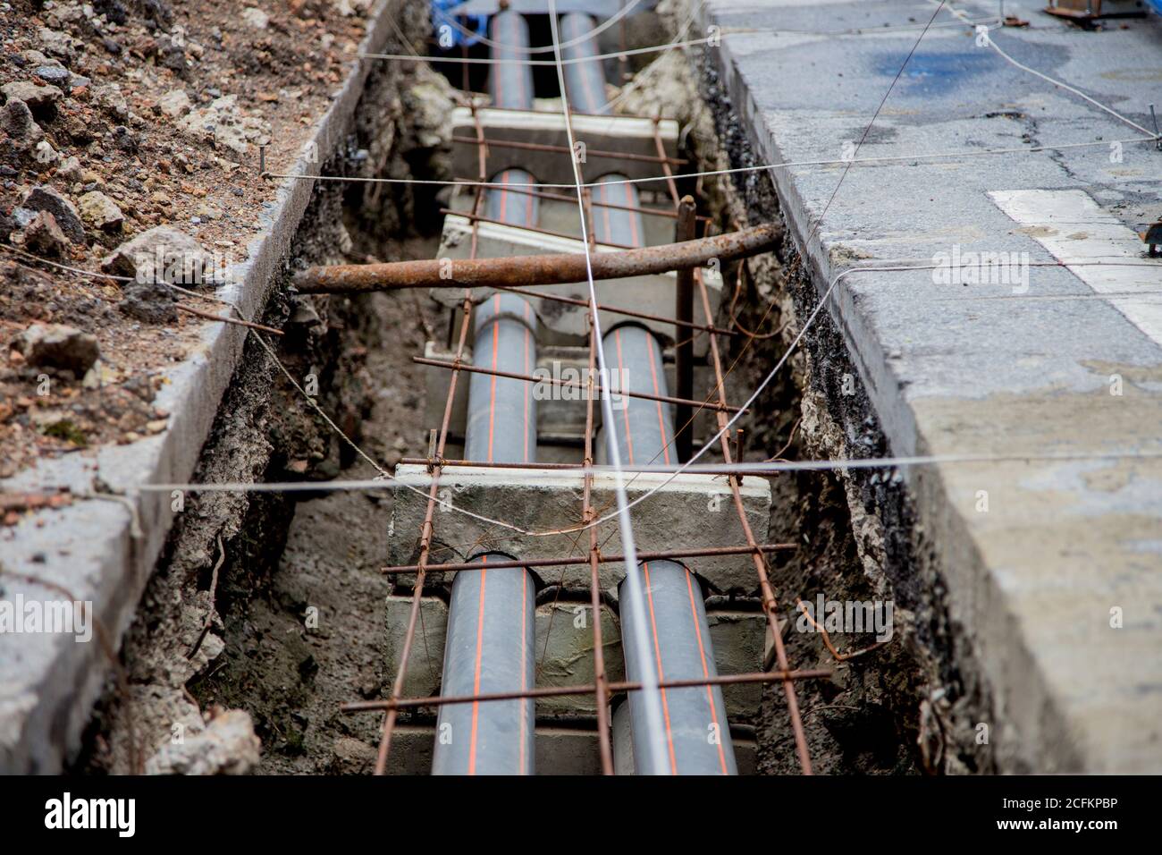 electric fiber underground of street in construction process urban city ...