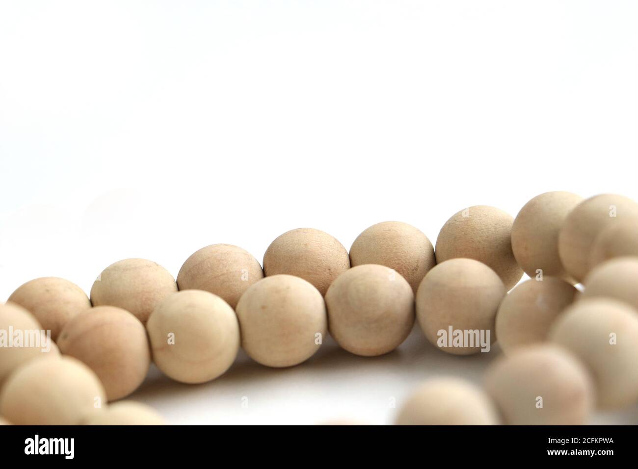A beautiful string of wooden beads isolated on a white background Stock ...
