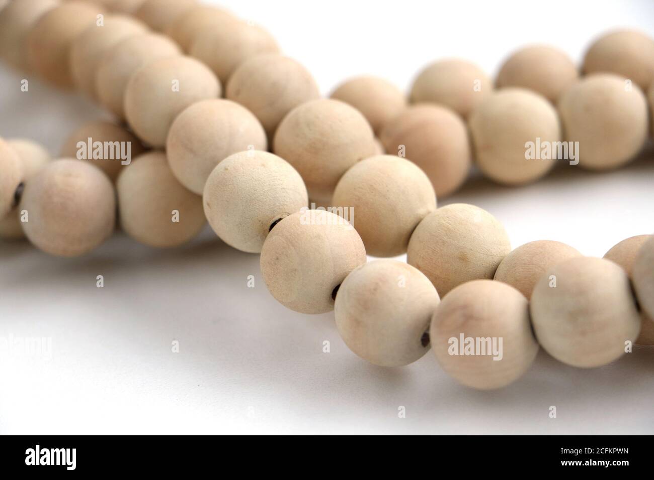 A beautiful string of wooden beads isolated on a white background Stock ...