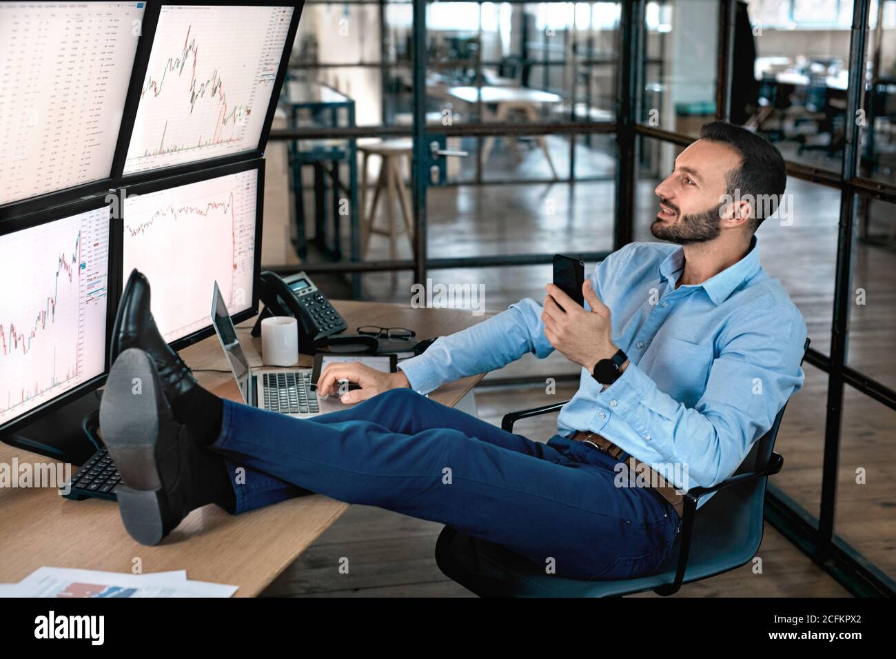 Stock Traiding. Trader sitting at office doing online trading talking ...
