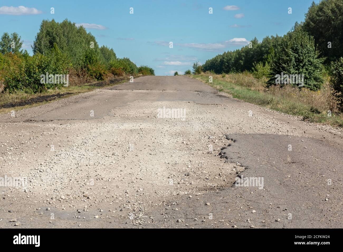 Destroyed asphalt cover on road. Bad road condition that needs repair ...