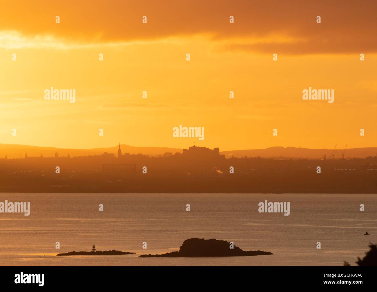 Sunrise over Edinburgh Castle seen from Dalgety Bay, Fife, Scotland ...