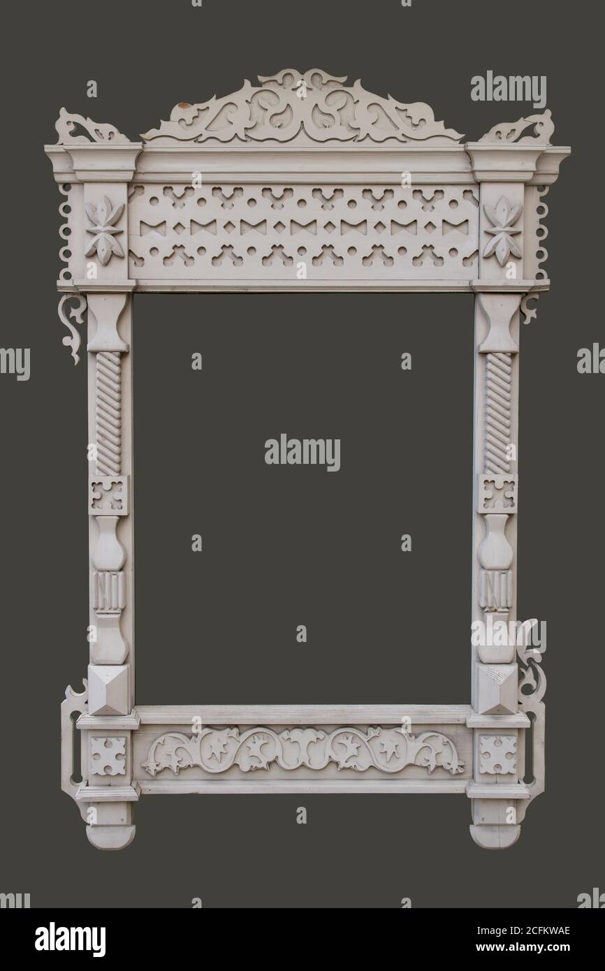 Elegant windows of a wooden house, beautiful carved platbands of ...