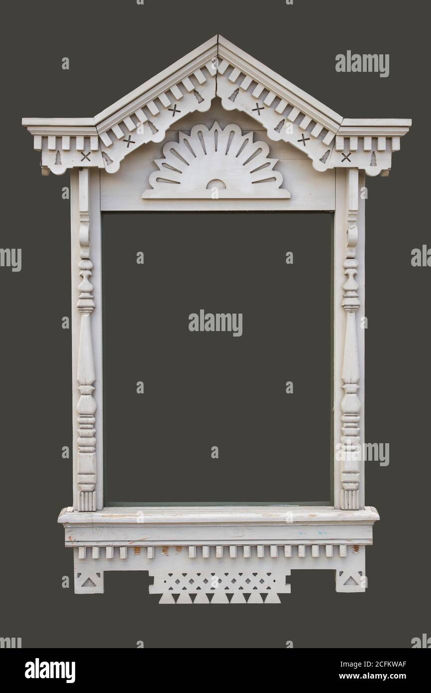 Elegant windows of a wooden house, beautiful carved platbands of ...