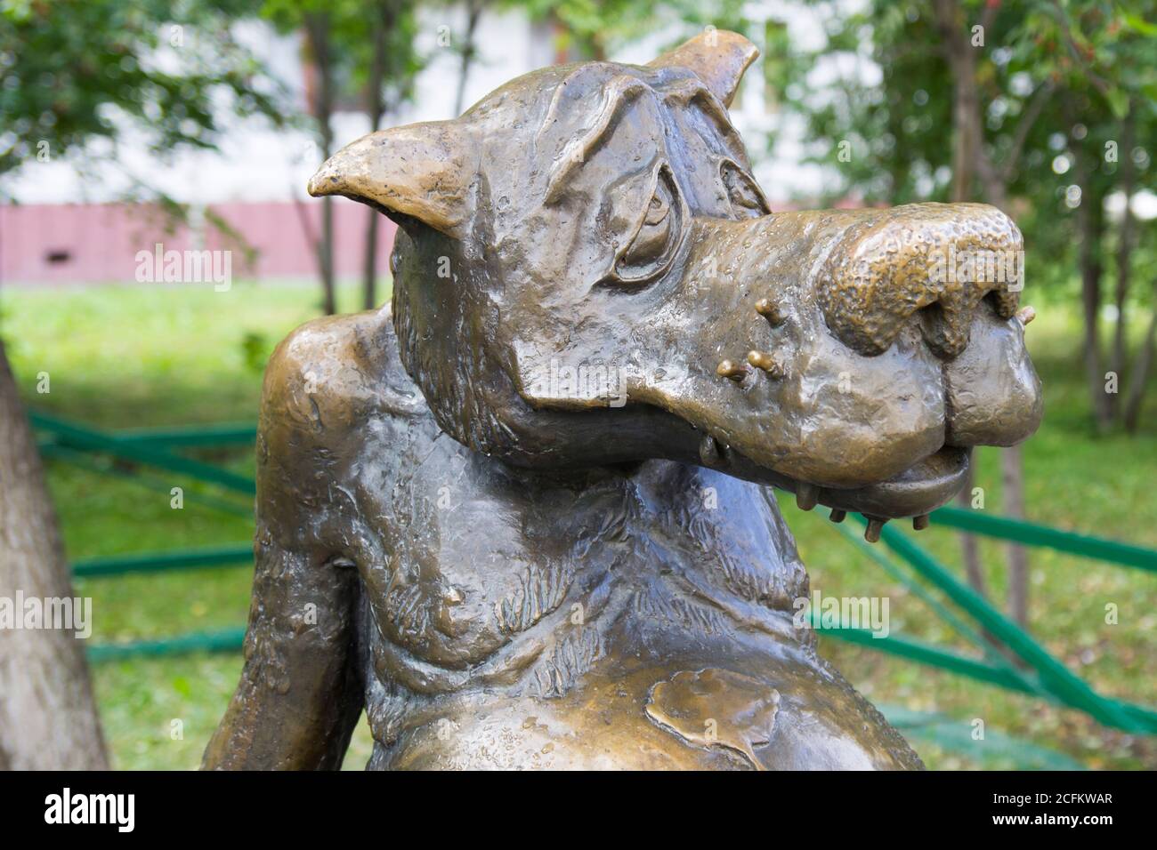 Monument of happiness. Sculpture of a well-fed wolf with a large belly ...