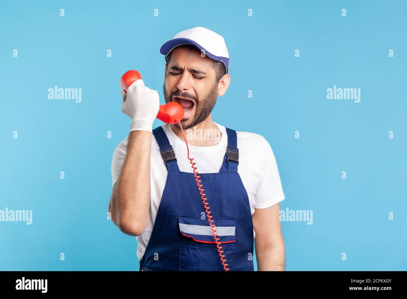 Housing maintenance call centre. Angry handyman in overalls, safety ...