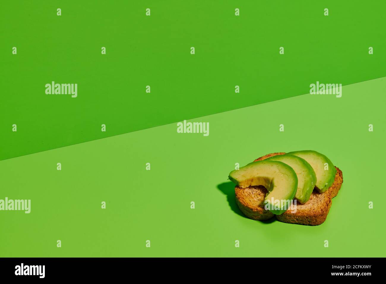 Delicious healthy bread toast with fresh sliced avocado placed on ...