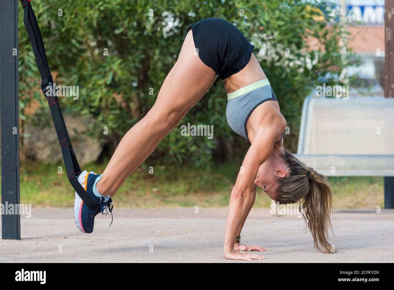 Side view of strong sportsWoman doing abdominal crunches while ...