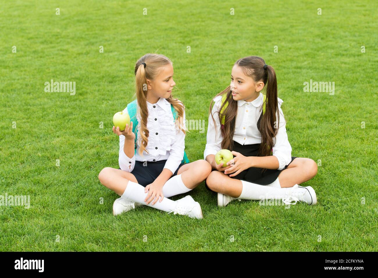 School students girls eating apples for lunch, eat healthy concept ...