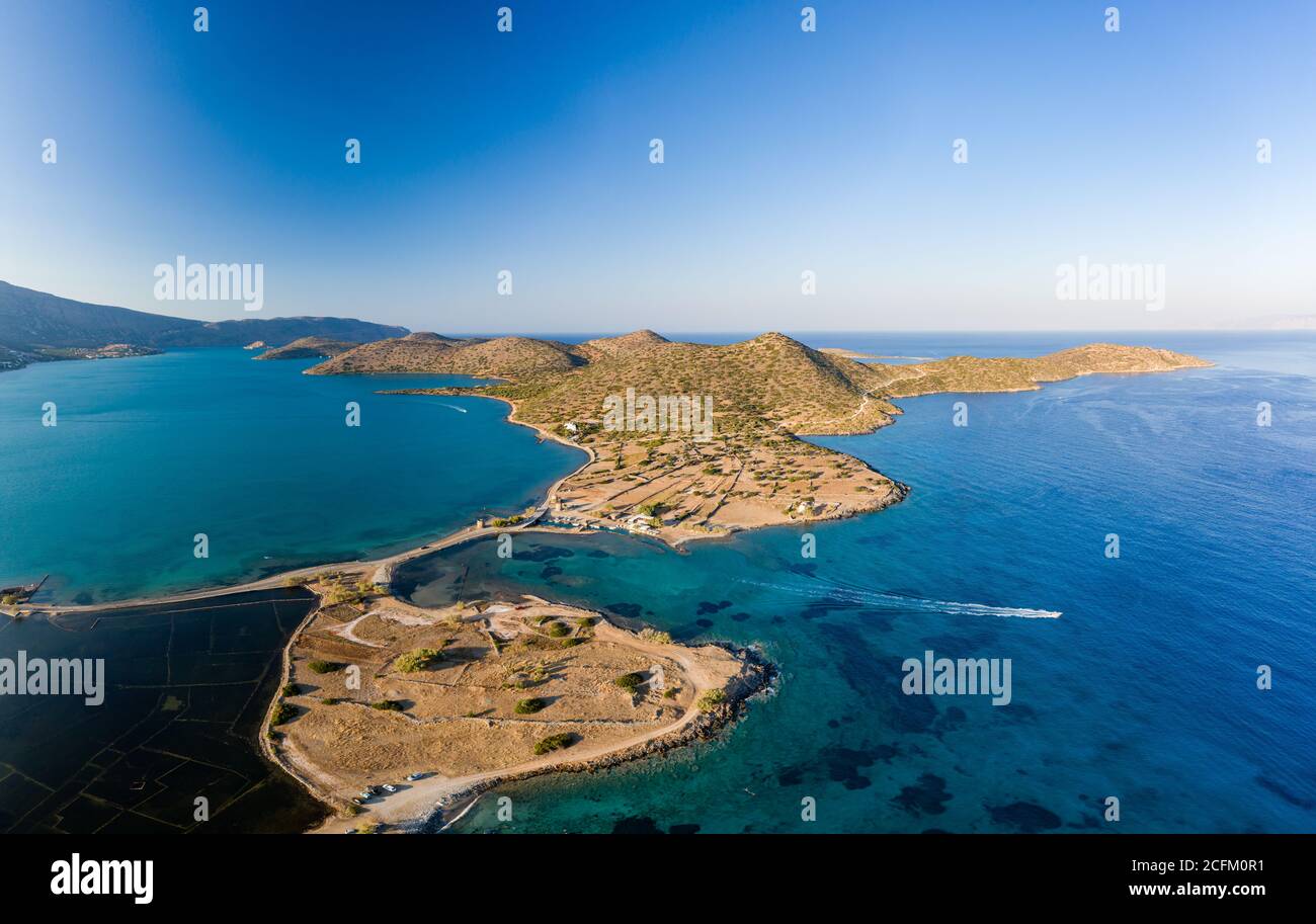 Aerial view of the crystal clear ocean and dry summer coastline of ...
