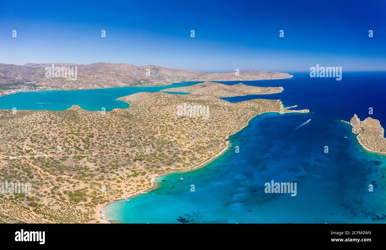 Aerial view of the rugged coastline of Crete and the clear waters of ...