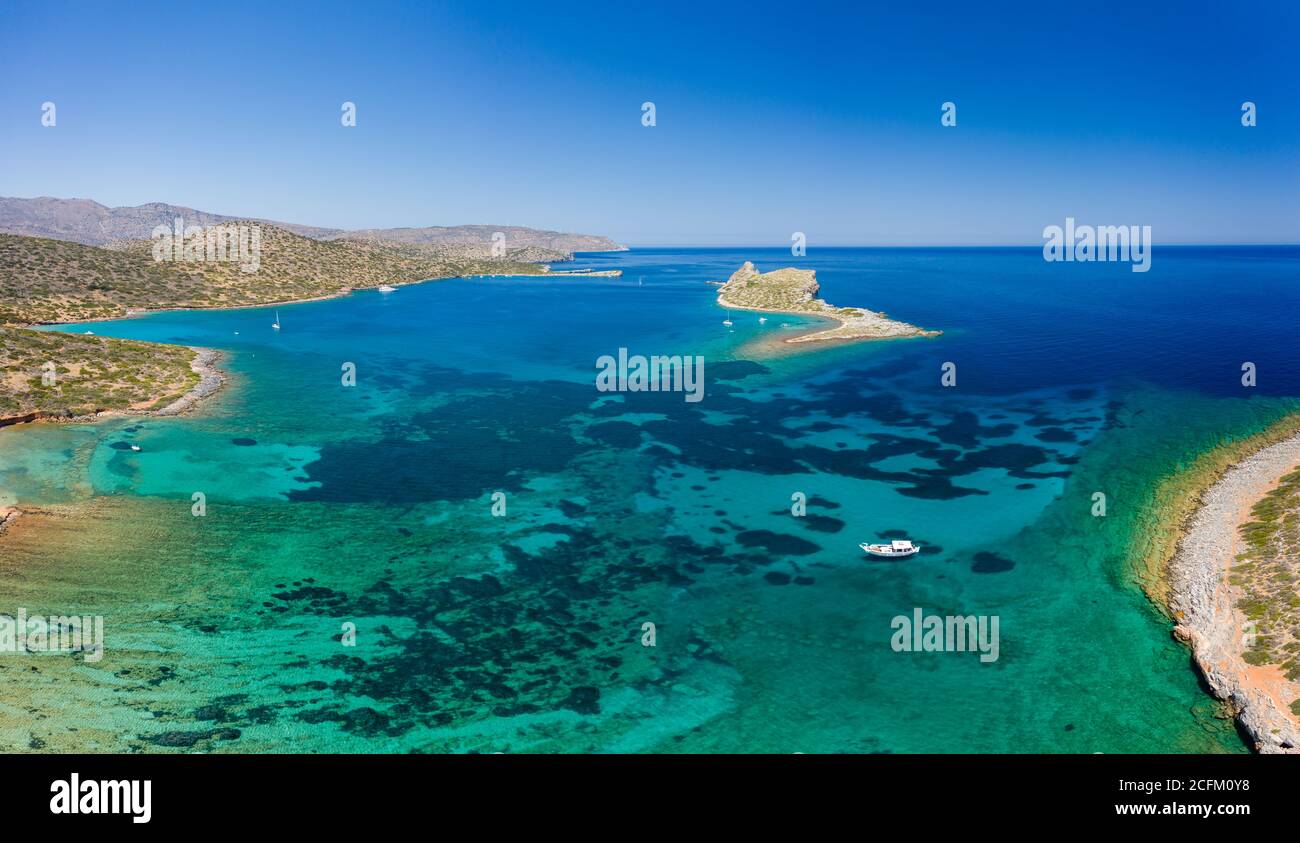 Aerial view of the coastline of Crete surrounded by the clear waters of ...