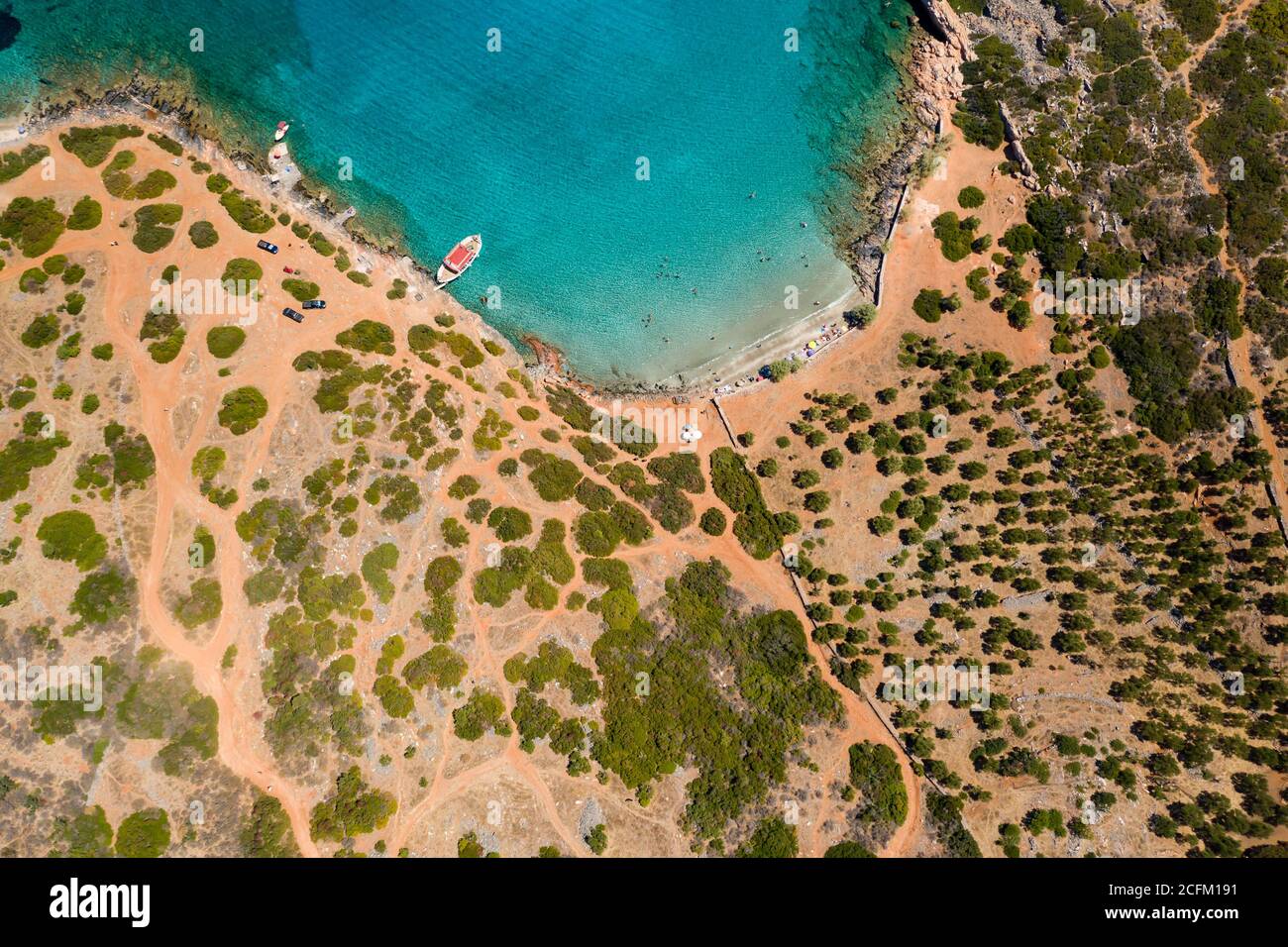 Aerial drone view of a small beach on a rocky, barren coastline and ...