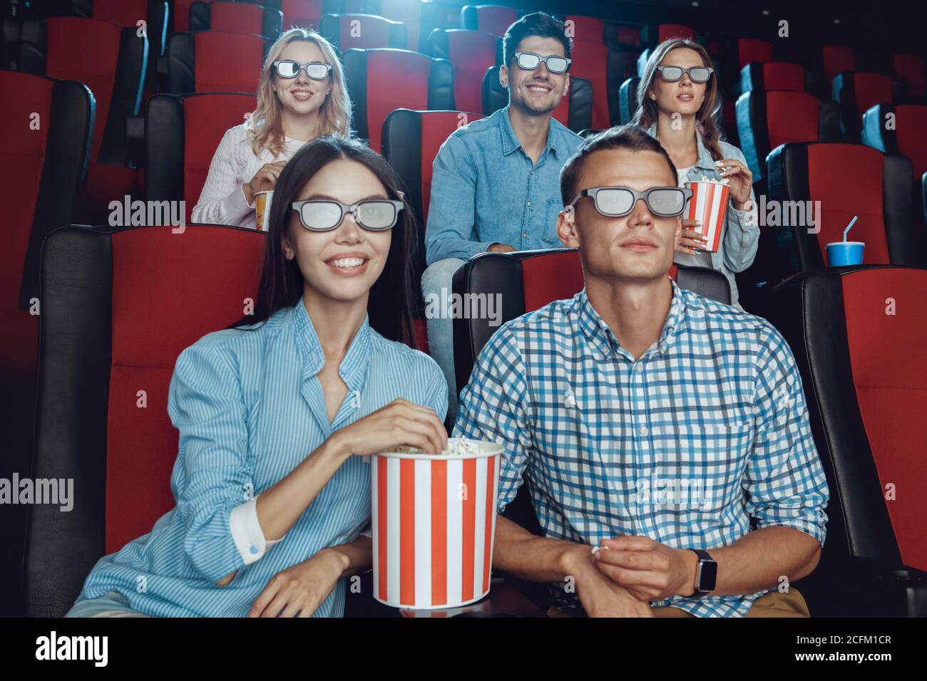 Young people friends together in the cinema Stock Photo - Alamy