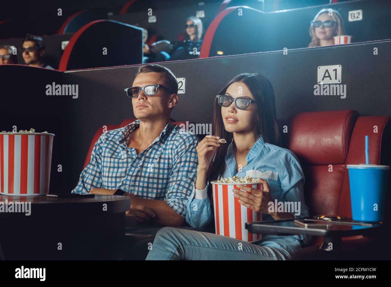 Young people friends together in the cinema Stock Photo - Alamy