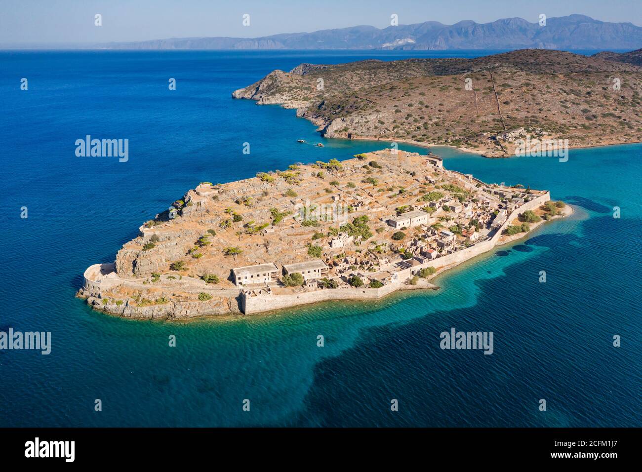 Aerial shot of the former Leper colony of Spinalonga island near Plaka ...