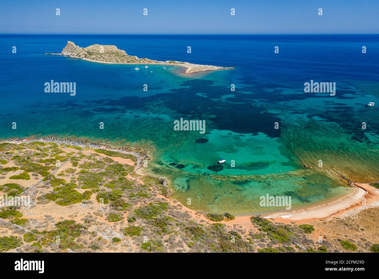Aerial view of the coastline of Crete surrounded by the clear waters of ...