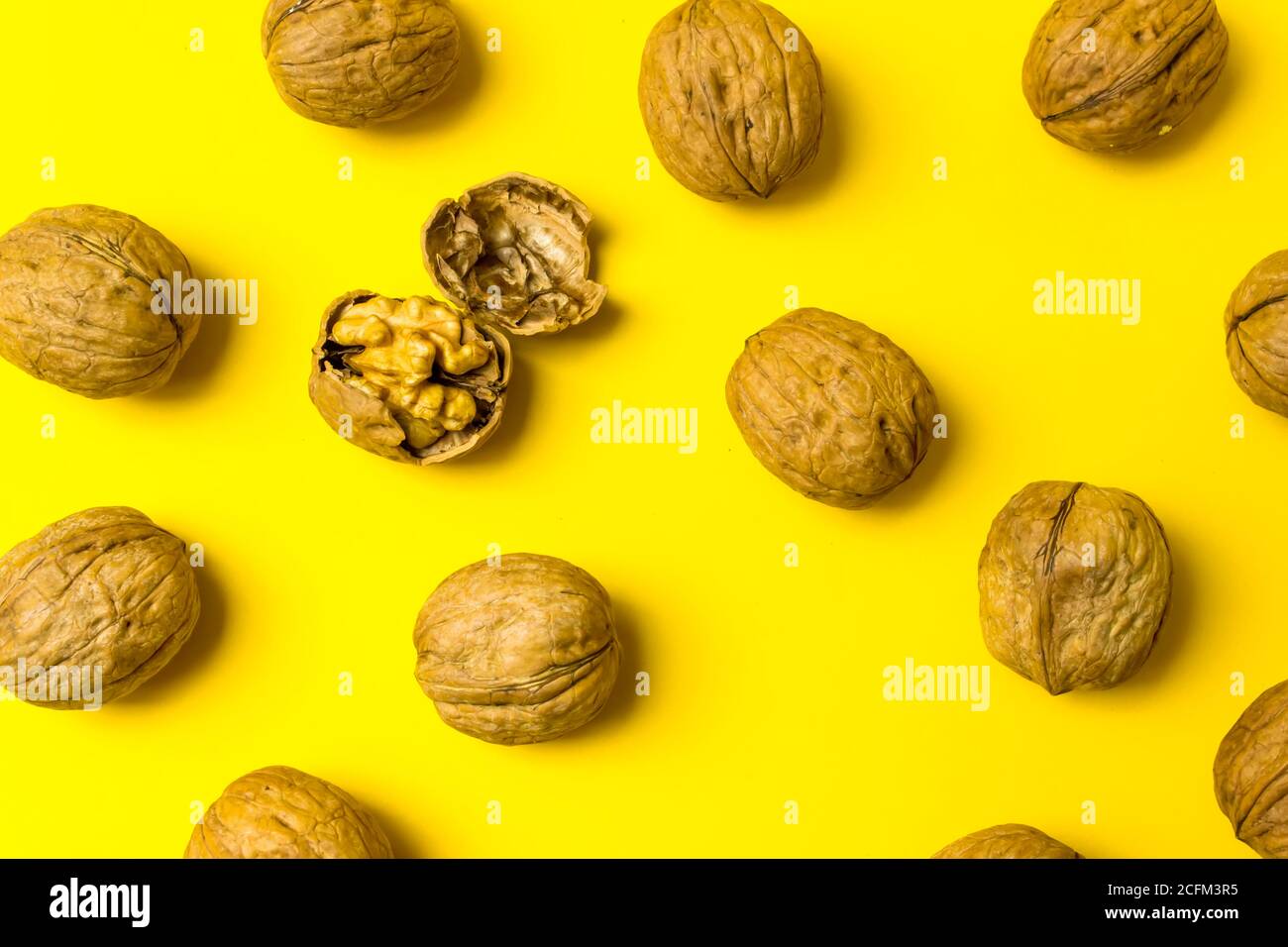 One peeled walnut among a group of ordinary nuts. Leader, individuality ...