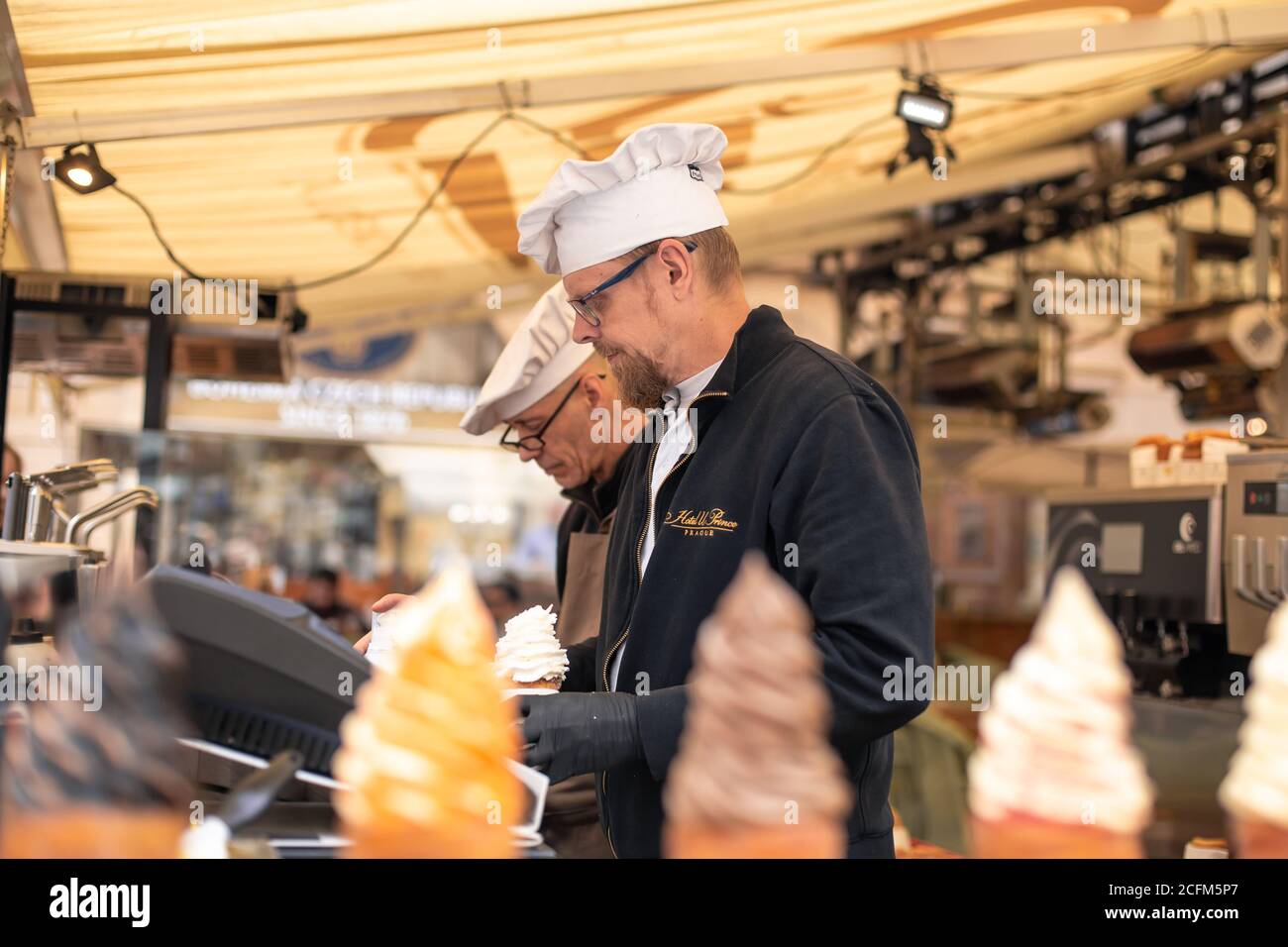 Two pastry chefs selling ice cream at a local candy store Stock Photo ...