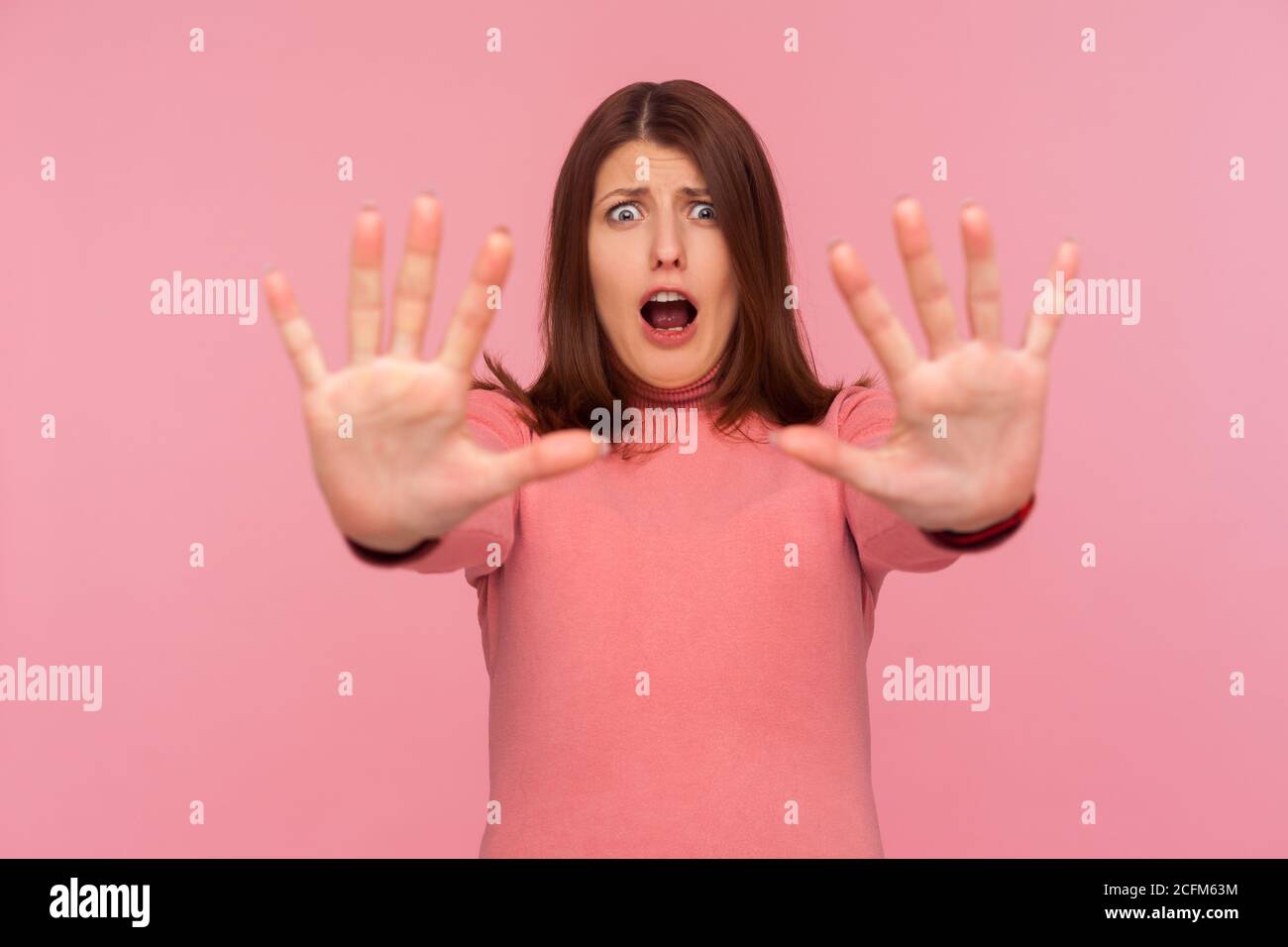 Unhappy scared woman with brown hair screaming with panic expression ...