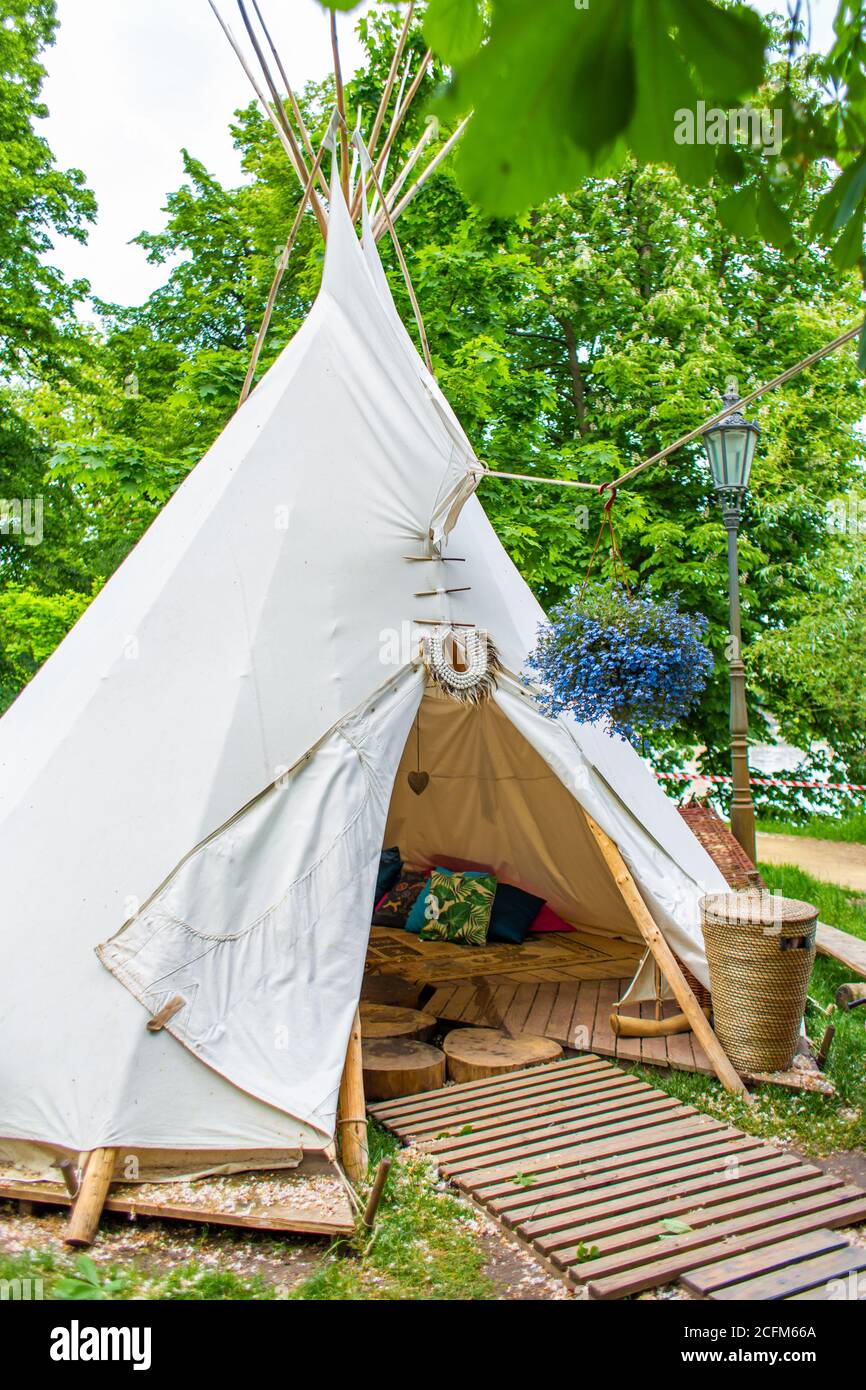 A tent in a summer cafe in a green park. Themed hipster cafe in the ...