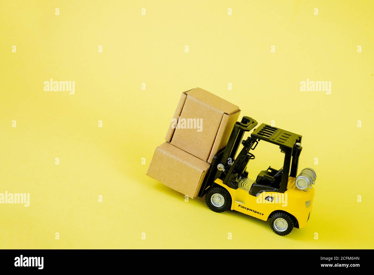 Mini forklift truck load cardboard boxes. Logistics and transportation ...