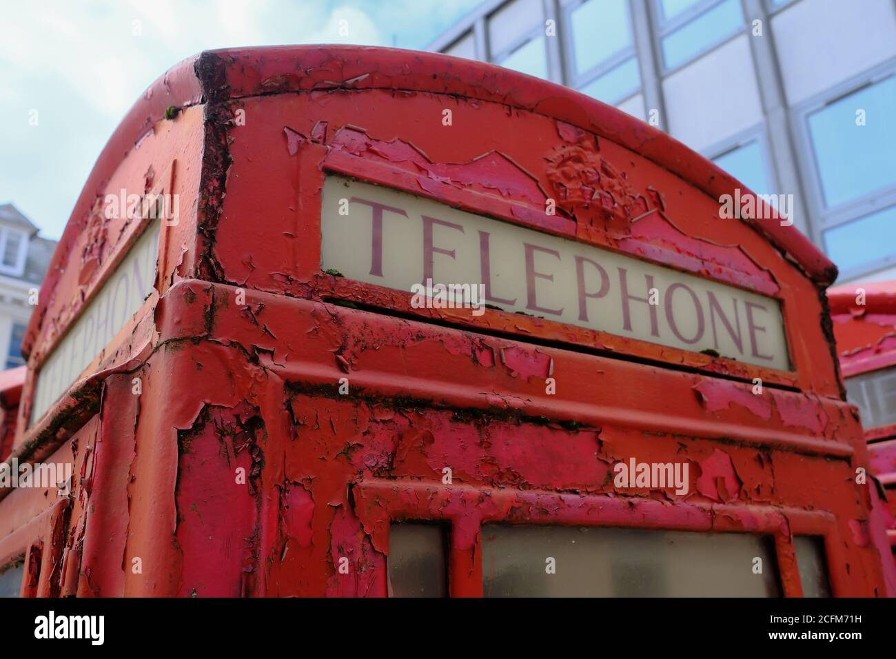 Old red telephone booth with rust and stripped paint Stock Photo - Alamy
