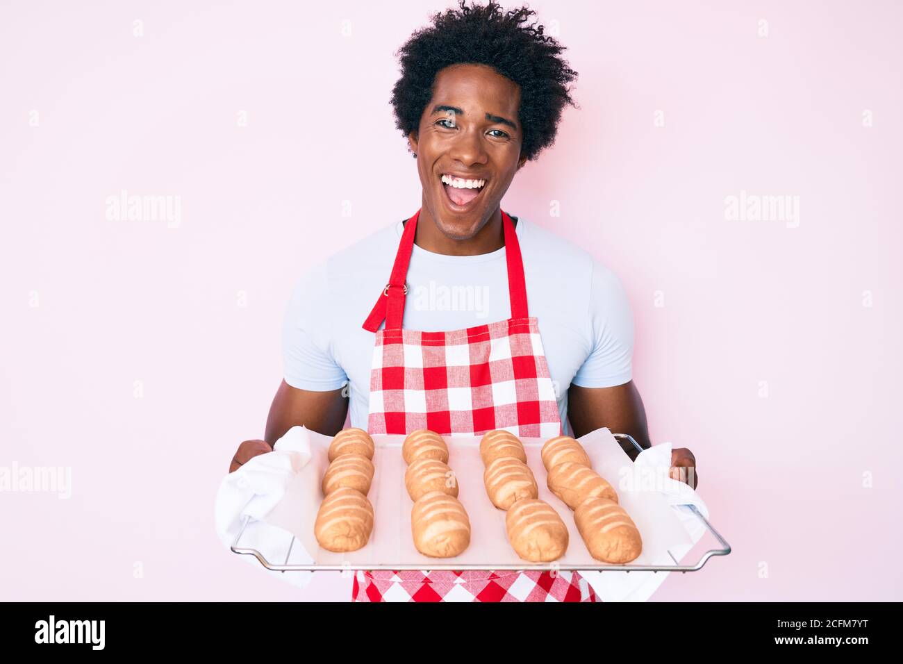Handsome african american man with afro hair wearing baker uniform ...