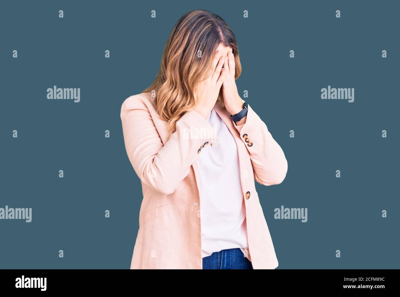 Young caucasian woman wearing business clothes with sad expression ...