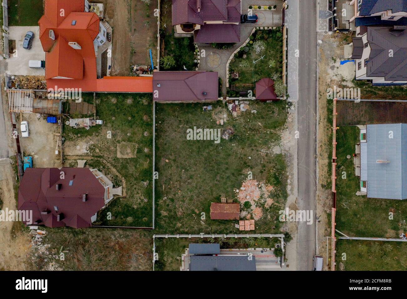 Aerial top view of a house with paved yard with green grass lawn with ...