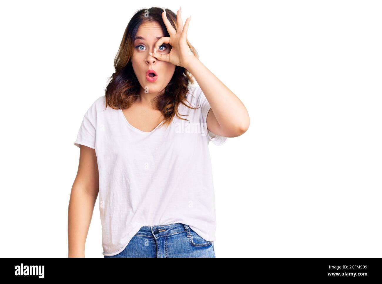 Young beautiful caucasian woman wearing casual white tshirt doing ok ...