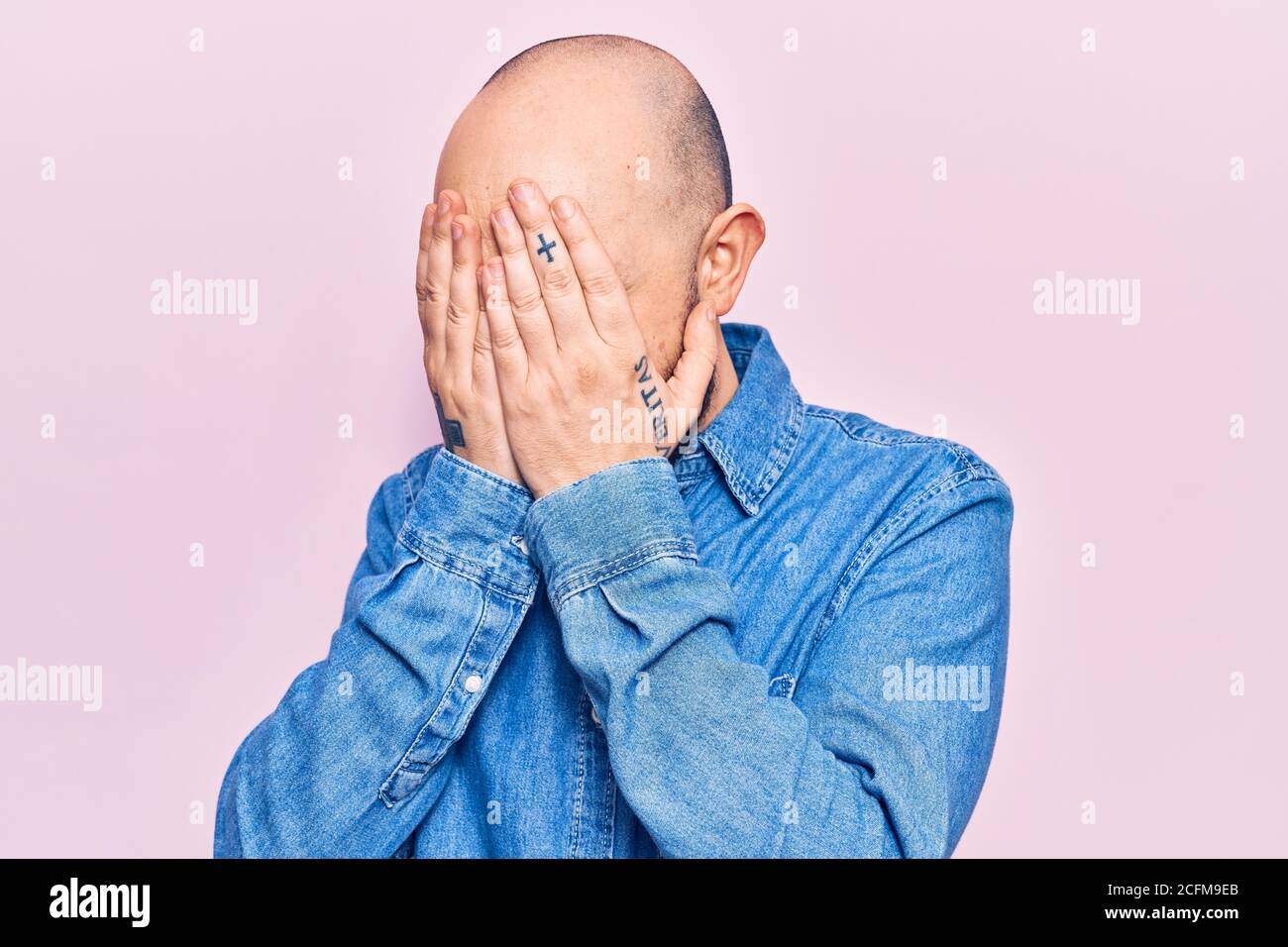 Young handsome man wearing casual clothes with sad expression covering ...