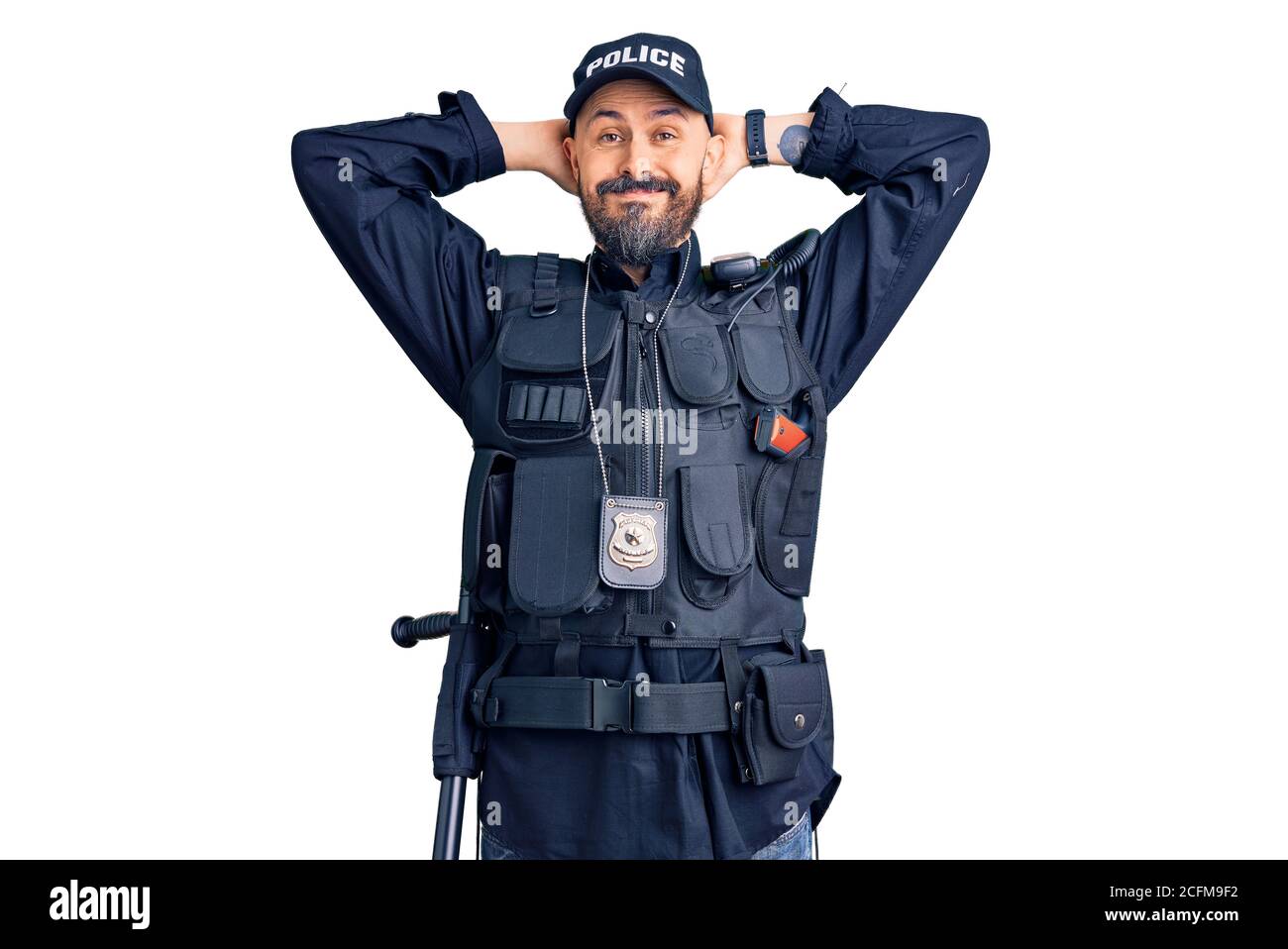 Young handsome man wearing police uniform relaxing and stretching, arms ...