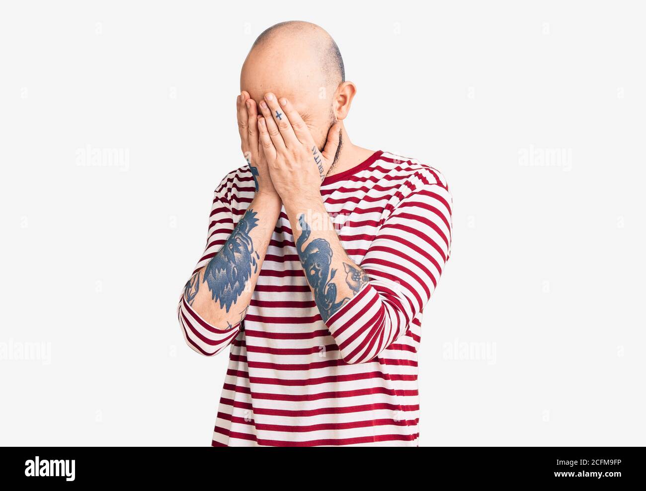 Young handsome man wearing casual clothes with sad expression covering ...