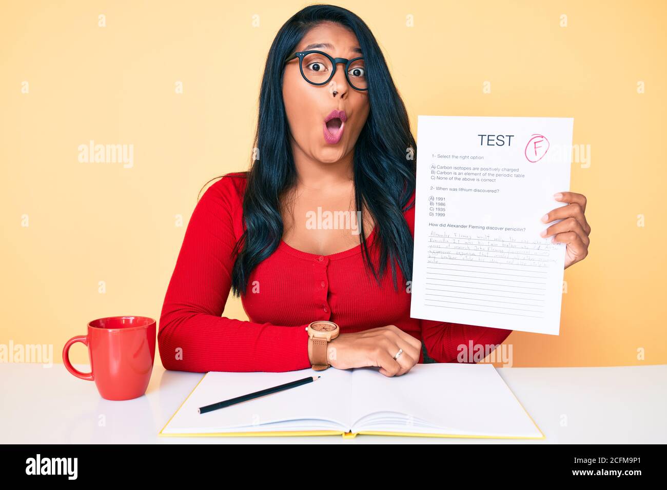 Beautiful latin young woman with long hair showing a failed exam scared ...