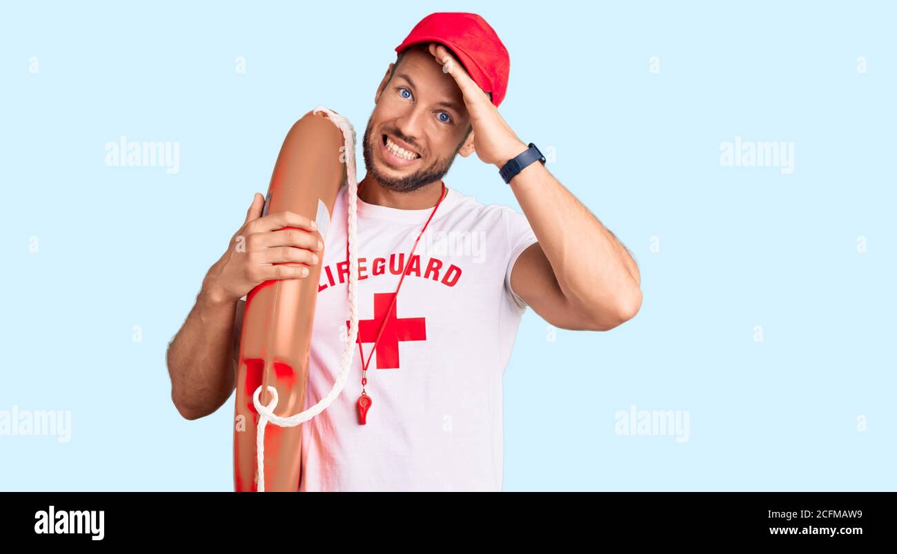 Young caucasian man wearing lifeguard t shirt holding float stressed ...