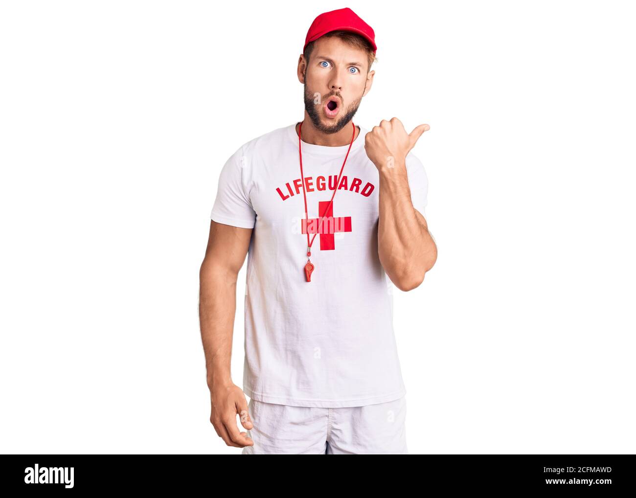 Young caucasian man wearing lifeguard t shirt holding whistle surprised ...