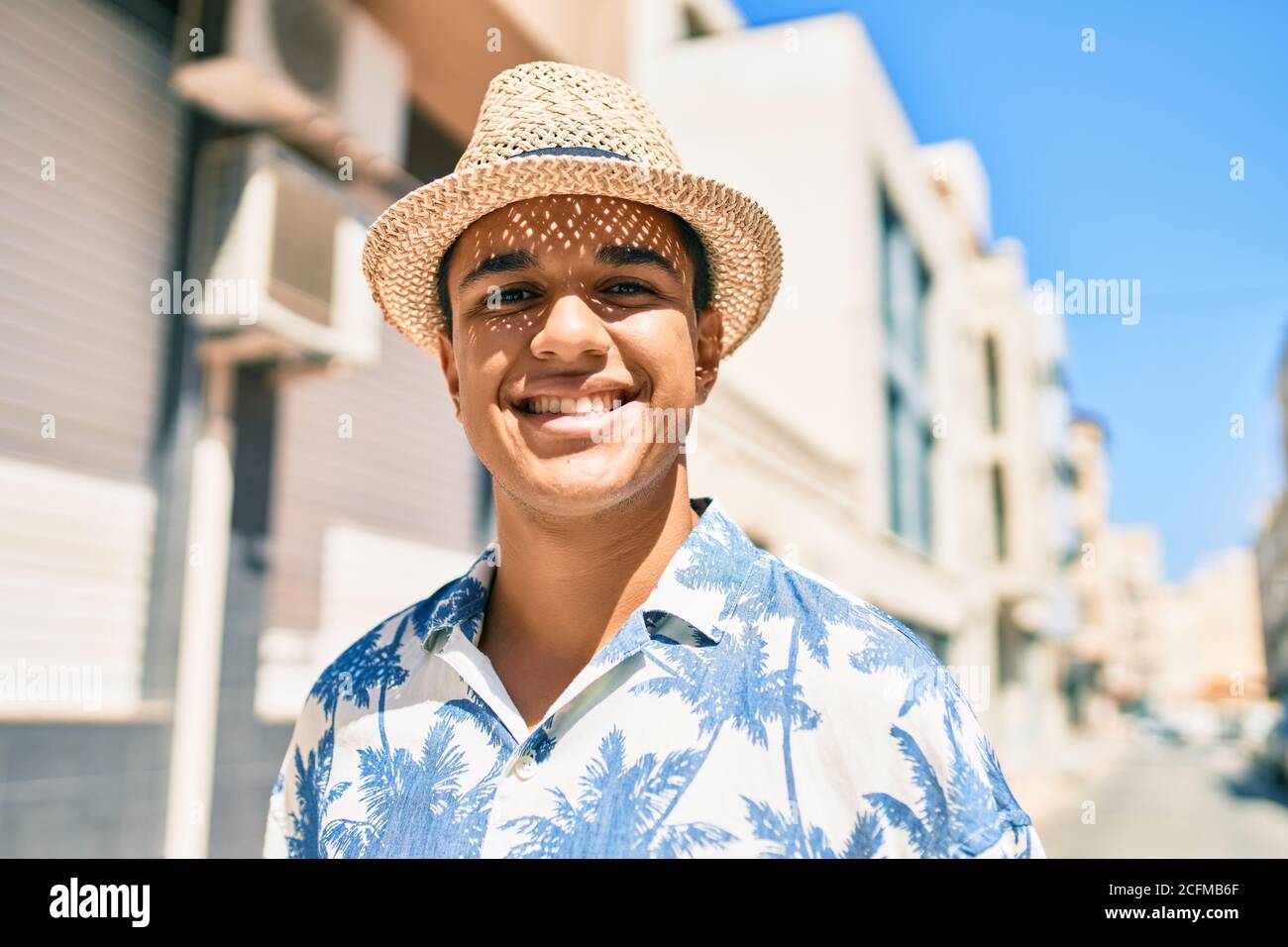 Young arab tourist man wearing summer style walking at street of city ...