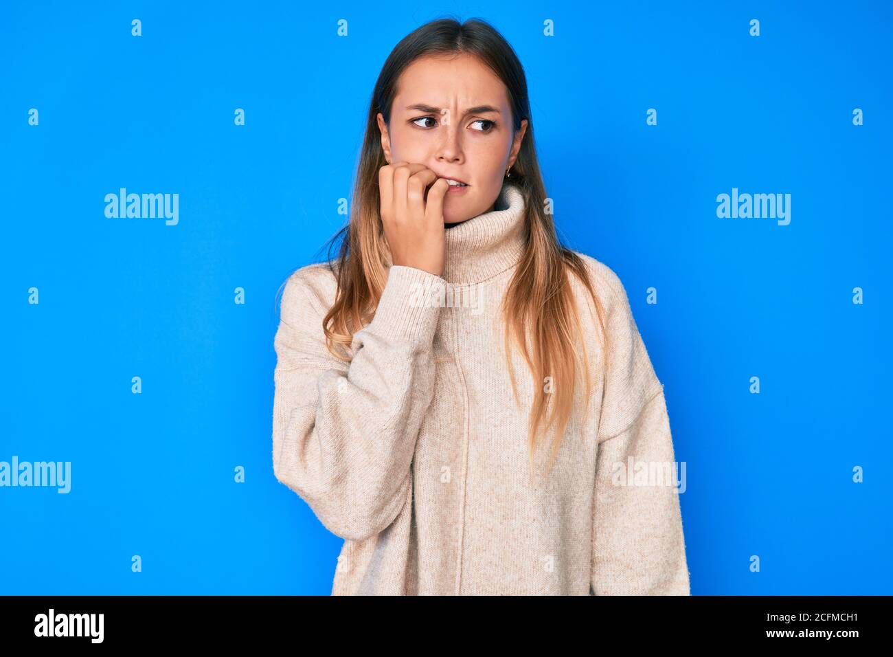 Beautiful caucasian woman wearing wool winter sweater looking stressed ...