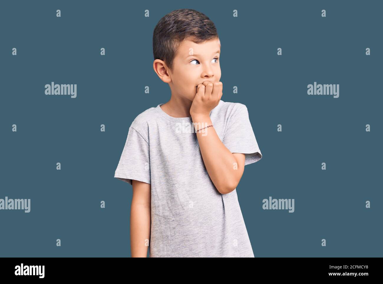 Cute blond kid wearing casual clothes looking stressed and nervous with ...