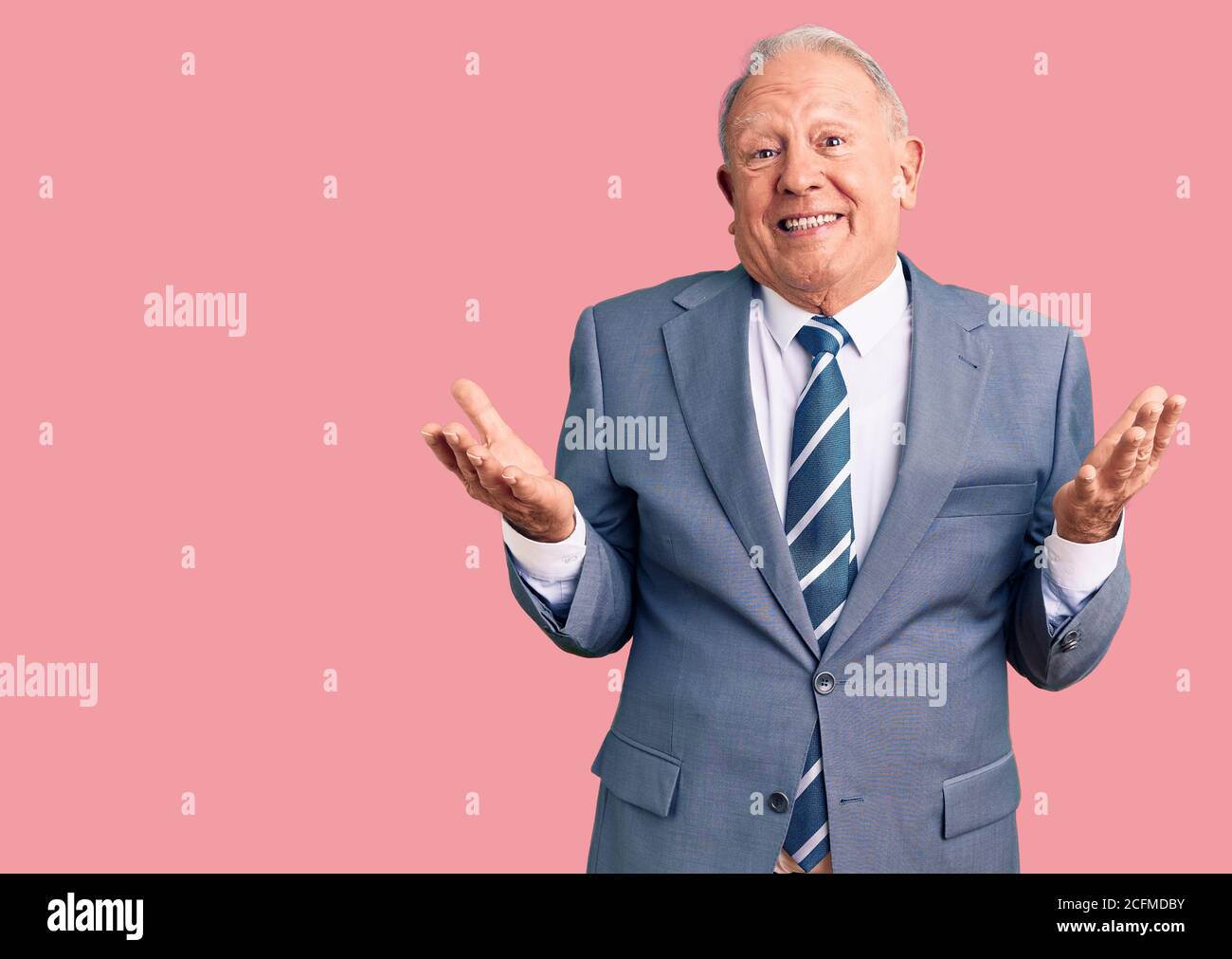 Senior handsome grey-haired man wearing elegant suit clueless and ...