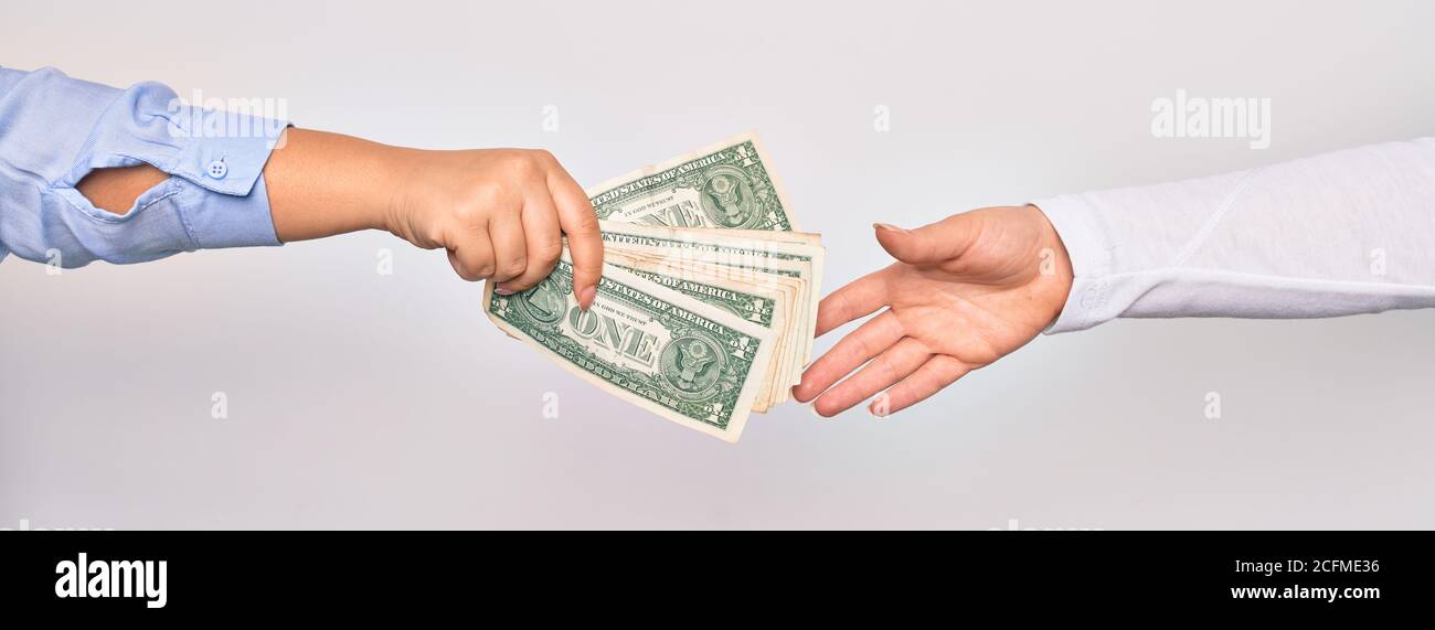 Two hands of caucasian young women doing transaction. Woman giving ...