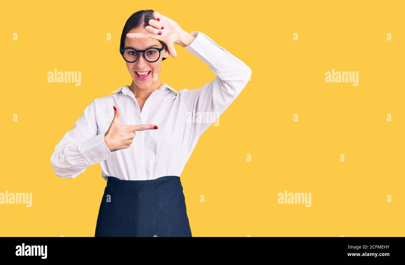 Beautiful brunette young woman wearing professional waitress apron ...